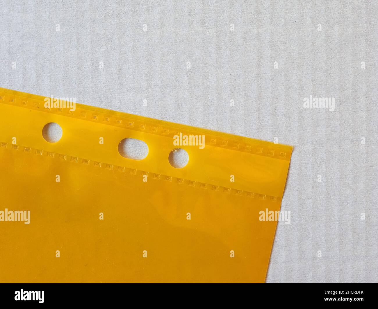 yellow punched pocket for A4 paper sheets Stock Photo - Alamy