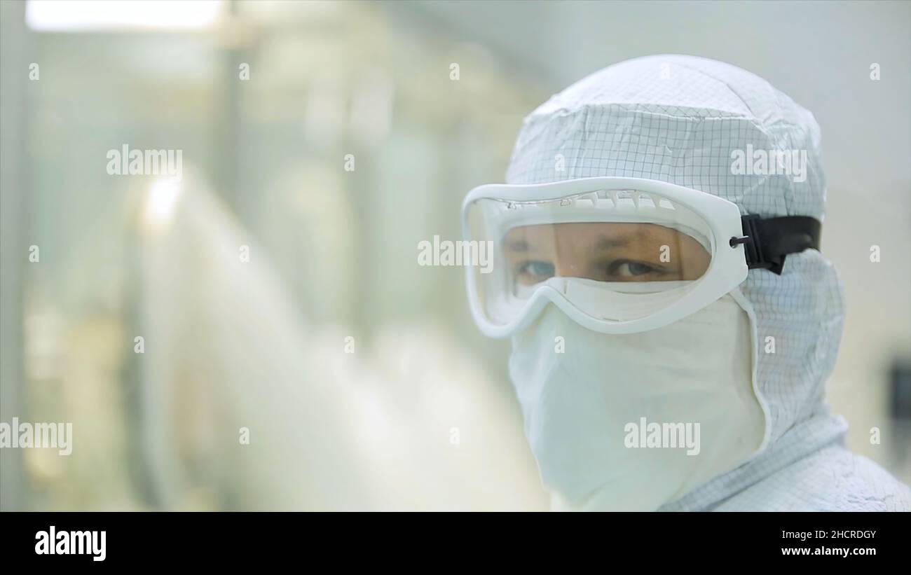 Pharmaceutics. Pharmaceutical worker operates blister packaging machine ...