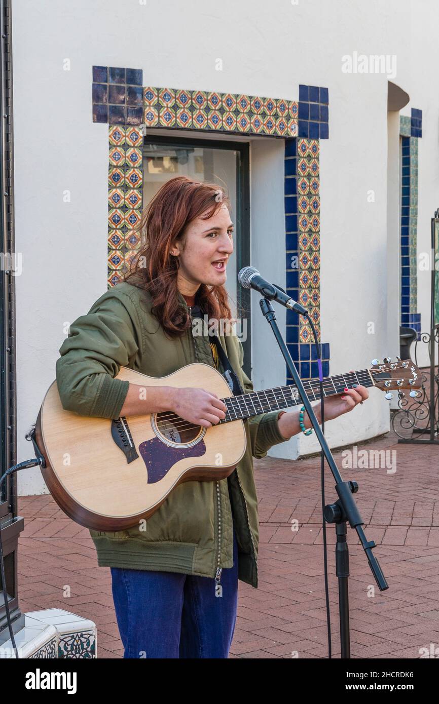 A female folk musician plays guitar outside Stock Photo - Alamy