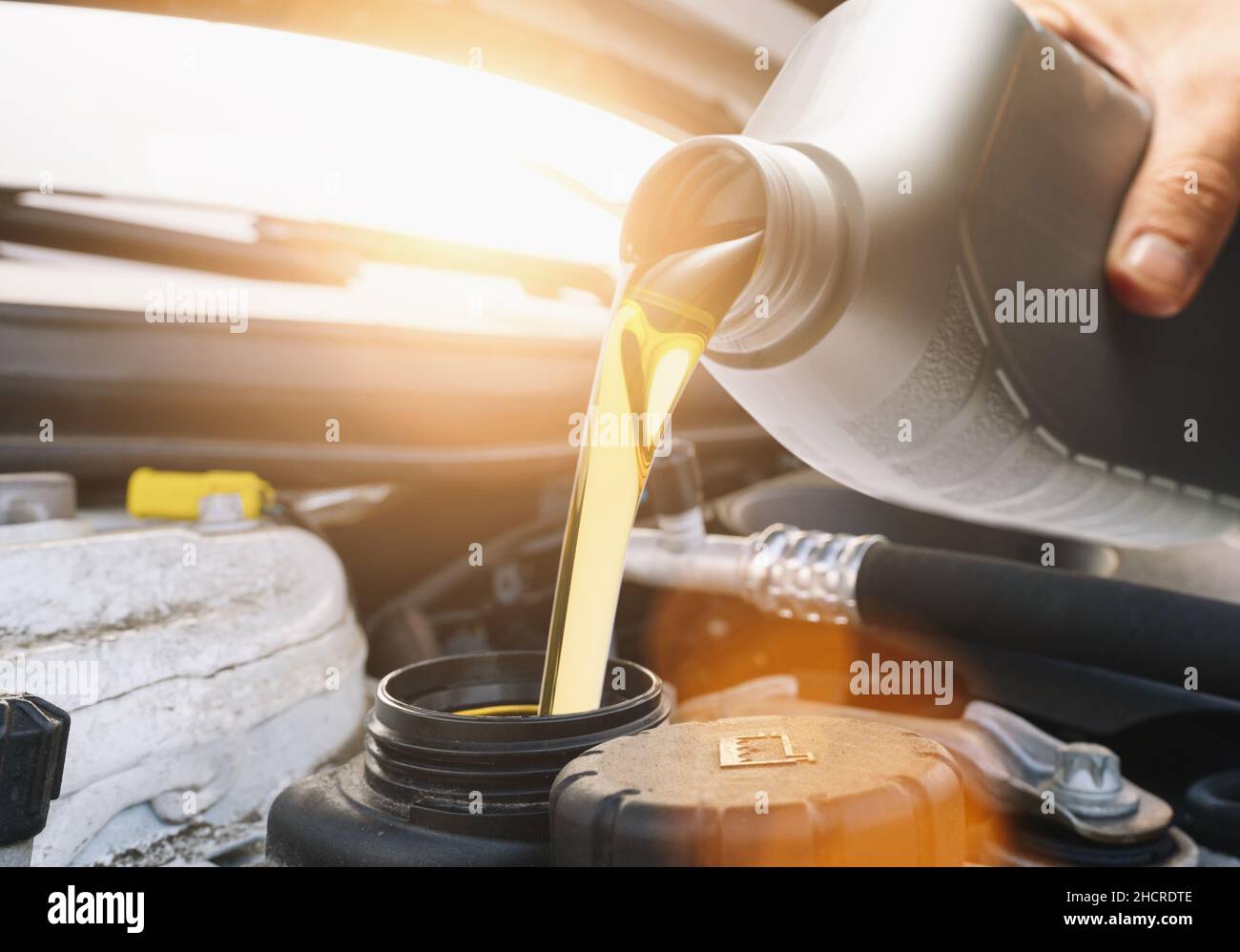 Motor oil pouring to car engine Stock Photo - Alamy