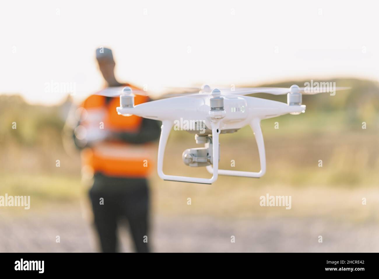 Drone inspection. Operator inspecting construction building site flying ...