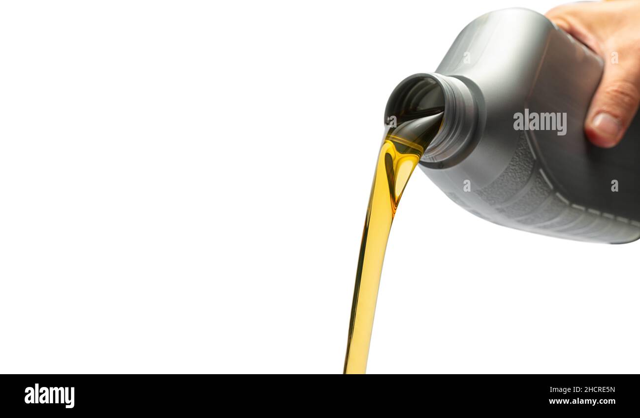 hand Pouring oil lubricant motor car from a bottle on isolated white ...