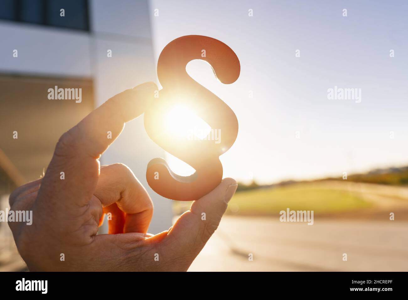 Hand holds paragraph as a sign of justice and Iustitia / Justitia the ...