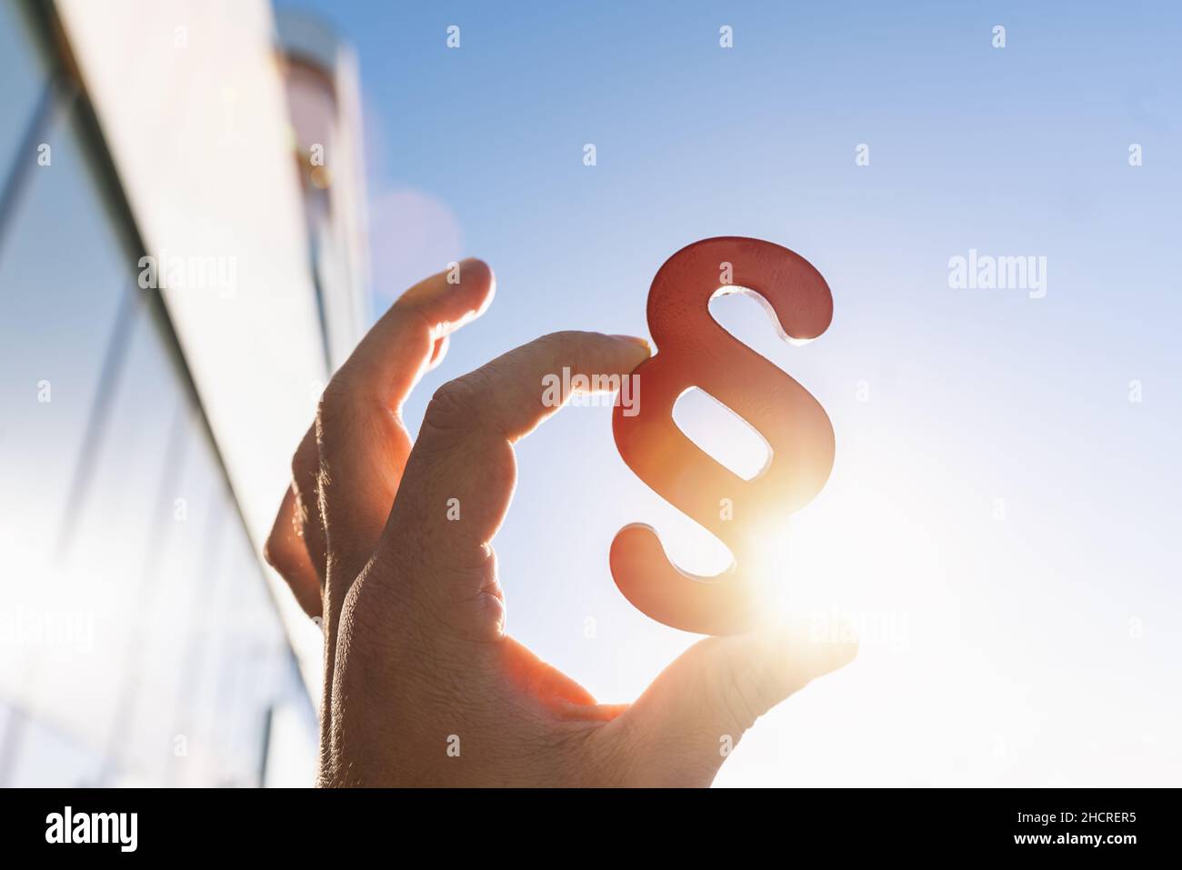 Hand holds paragraph in the sun as a sign of justice Stock Photo - Alamy