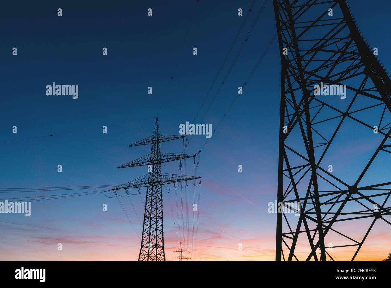 electric power transmission lines at sunset Stock Photo - Alamy