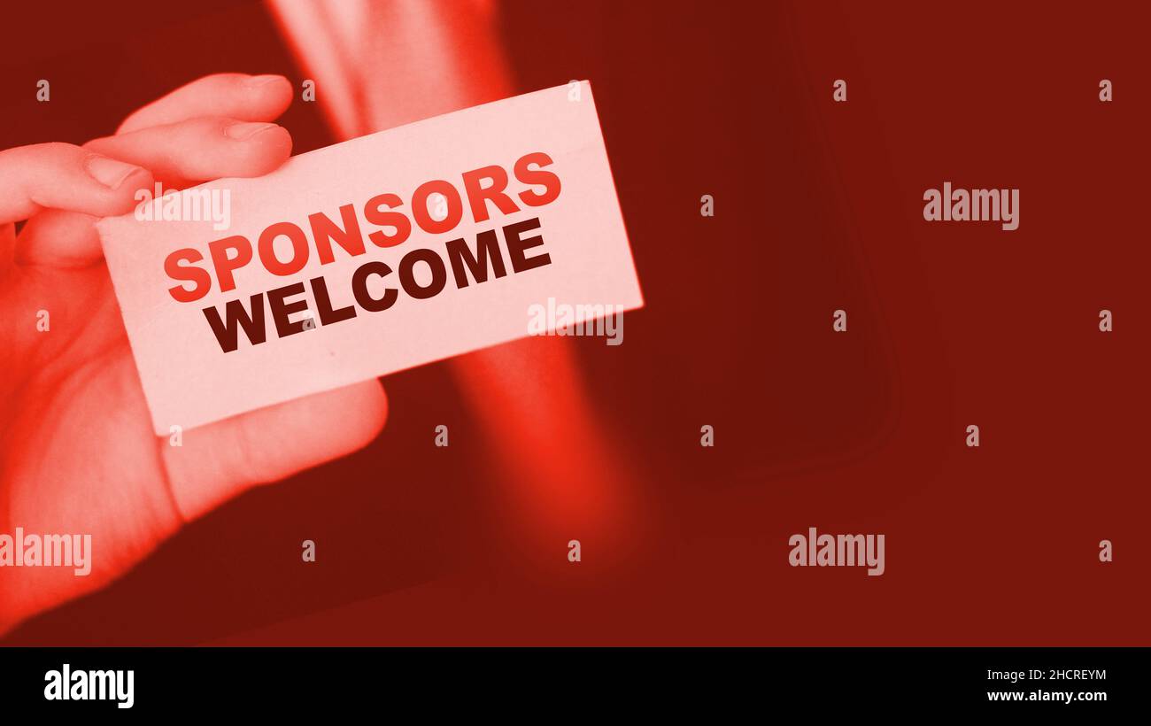 Businessman shows a card with text Sponsors Welcome. Fundrising ...