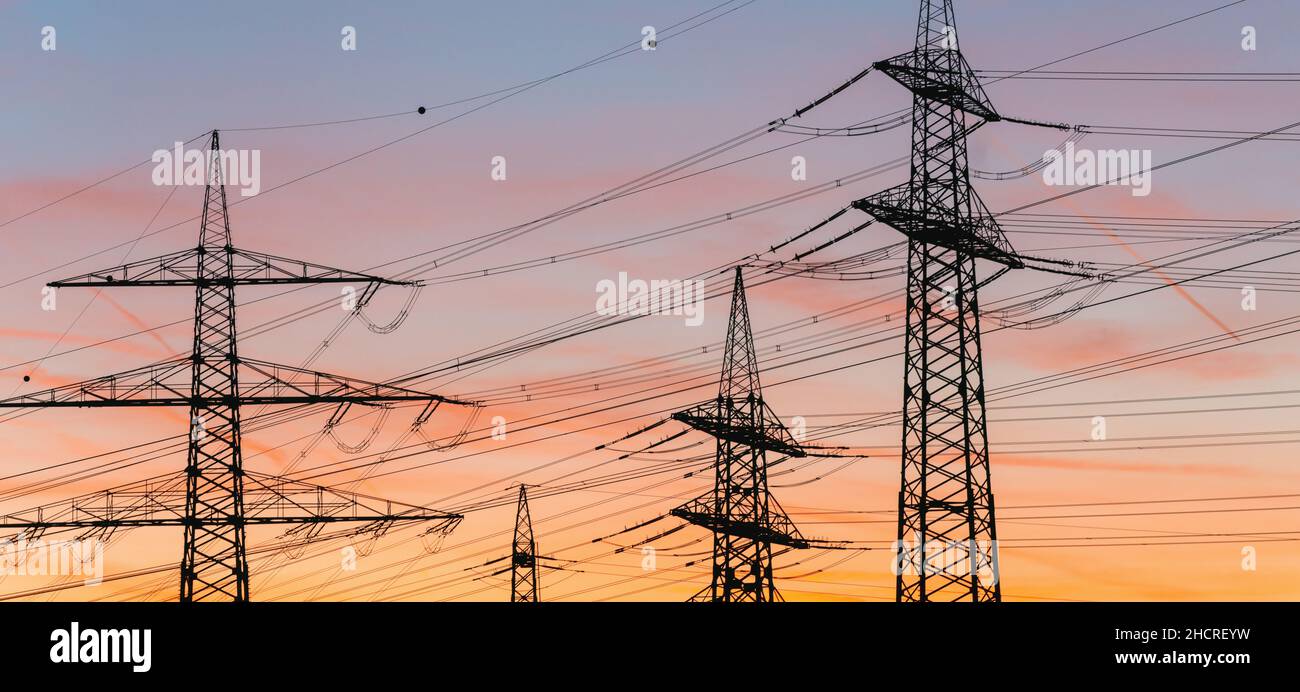 electric power transmission lines at sunset Stock Photo - Alamy