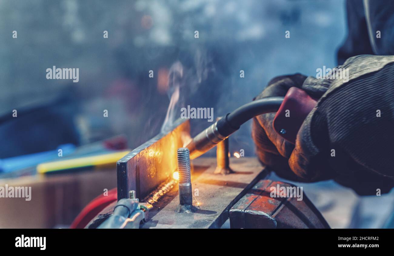 Industrial Worker welding the iron Stock Photo - Alamy