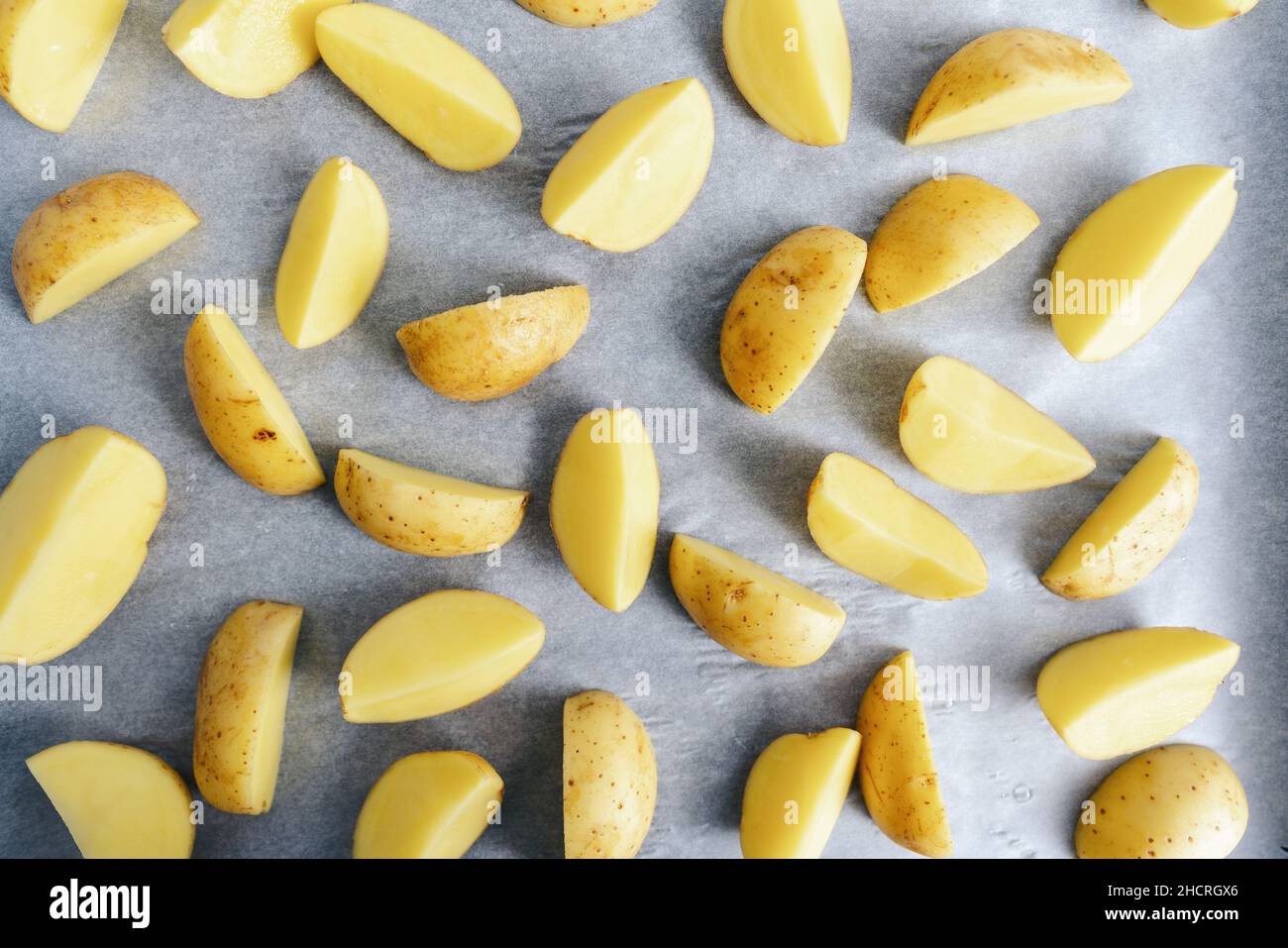 raw potato wedges on baking tray Stock Photo - Alamy