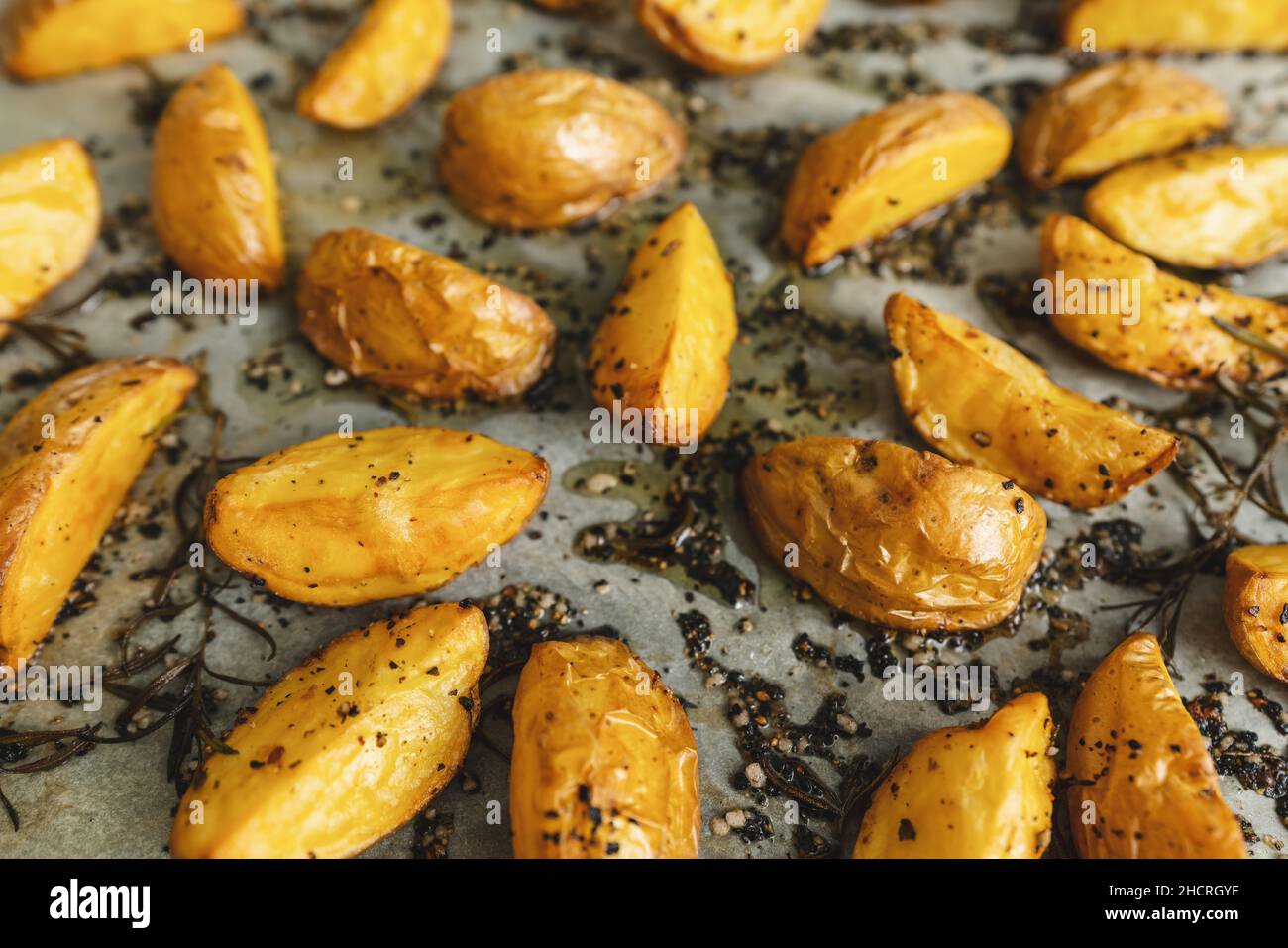 Baked potato wedges with rosemary and oil Stock Photo - Alamy