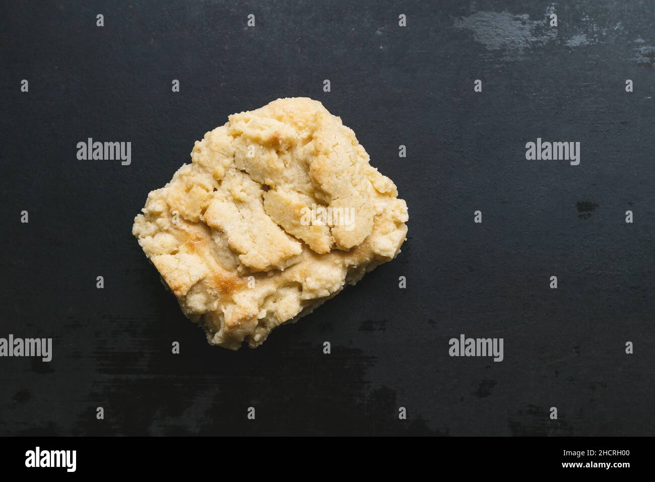 streusel bun or roll on black table, with copy space for individual ...