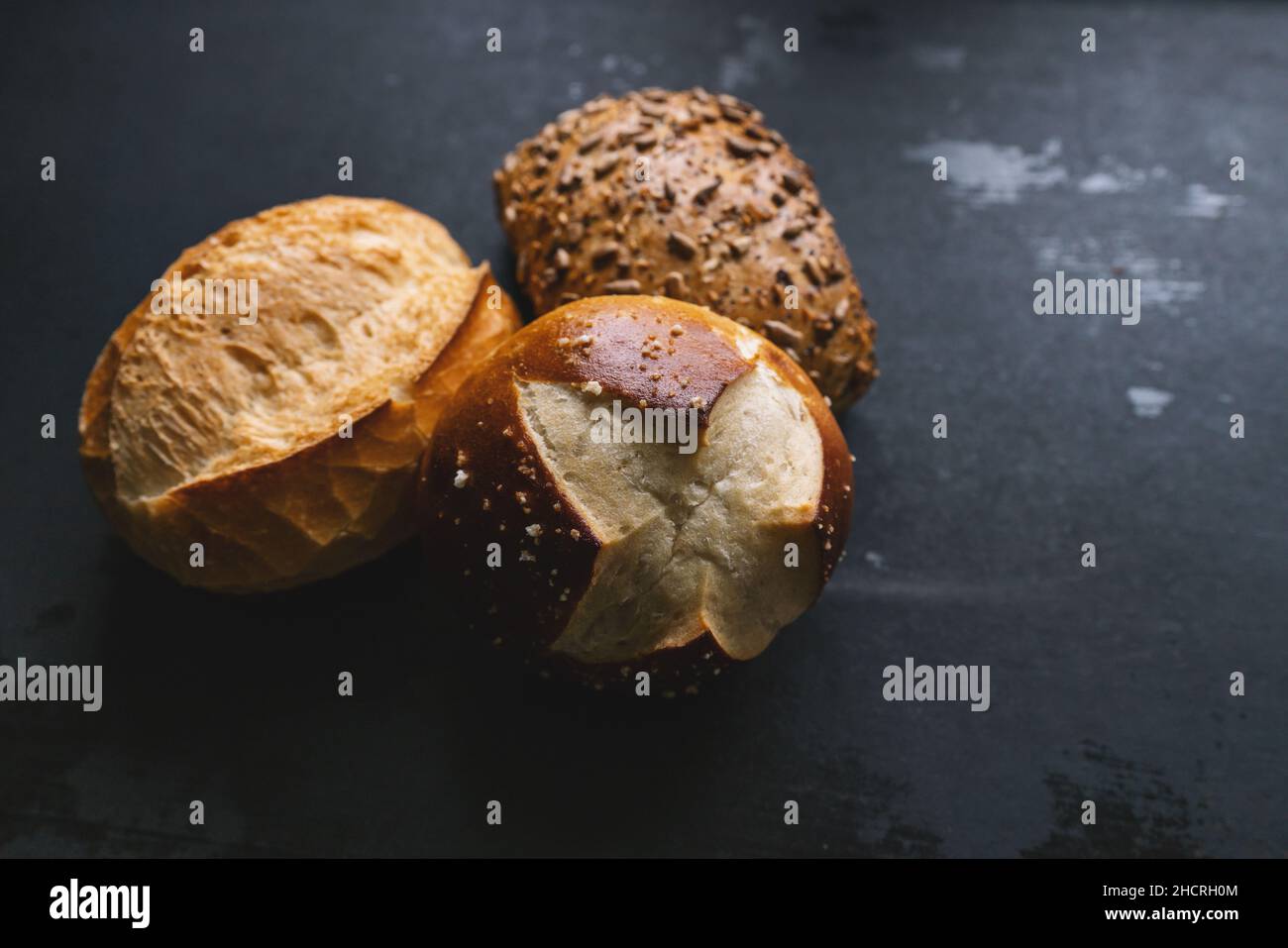 Different kinds of bread rolls on black board Stock Photo - Alamy