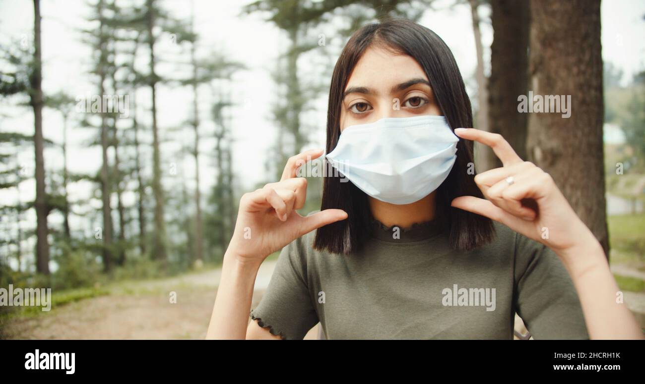 Indian female with a mask in the forest on a sunny day Stock Photo - Alamy