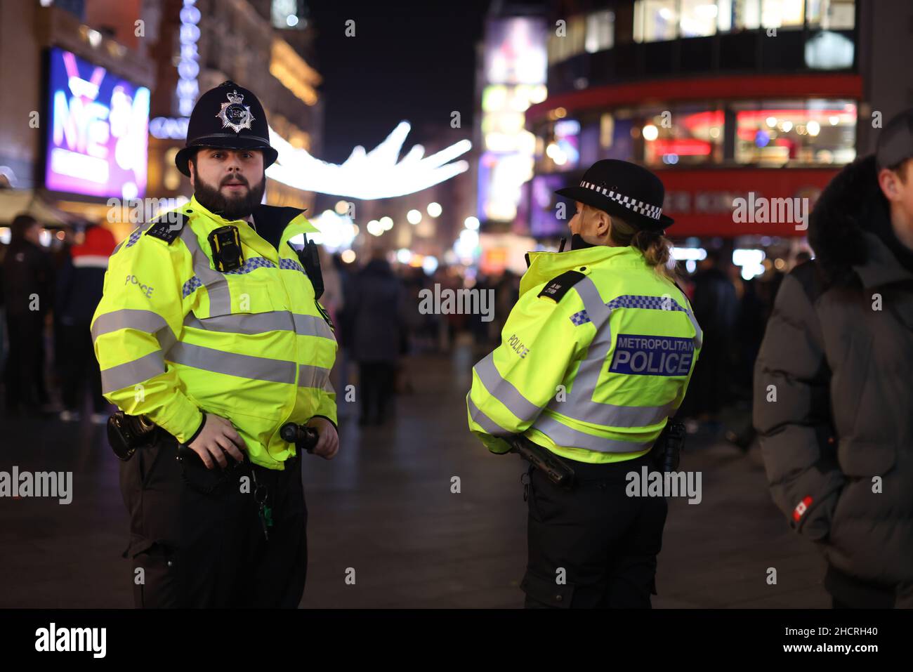 Police officers keep an eye on revellers ahead of New Year's Eve ...
