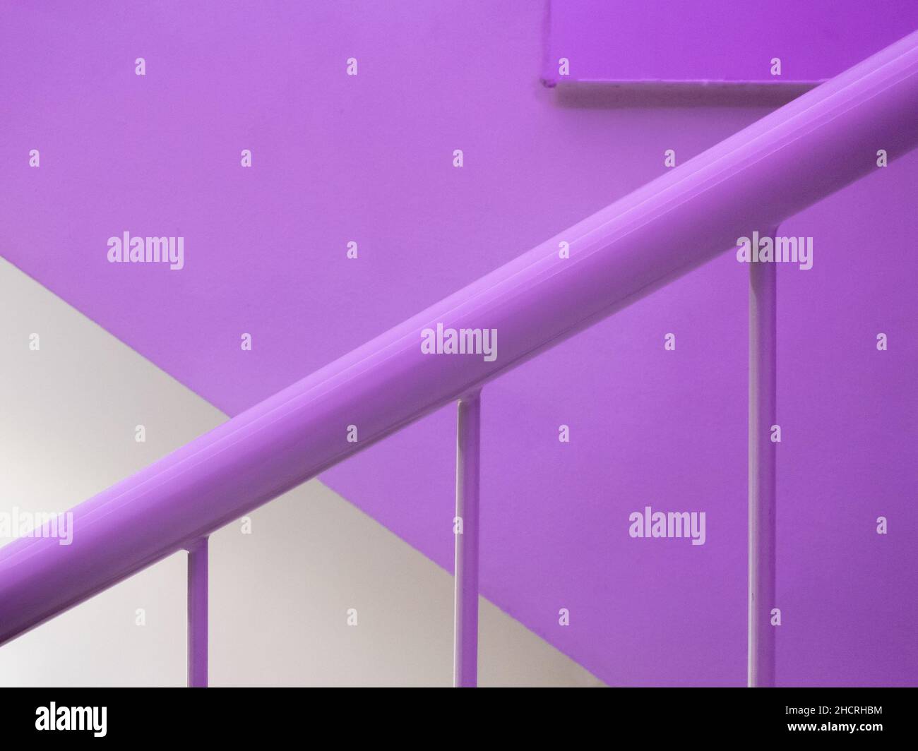 Closeup of a purple stair railing with metal poles, interiors modern ...