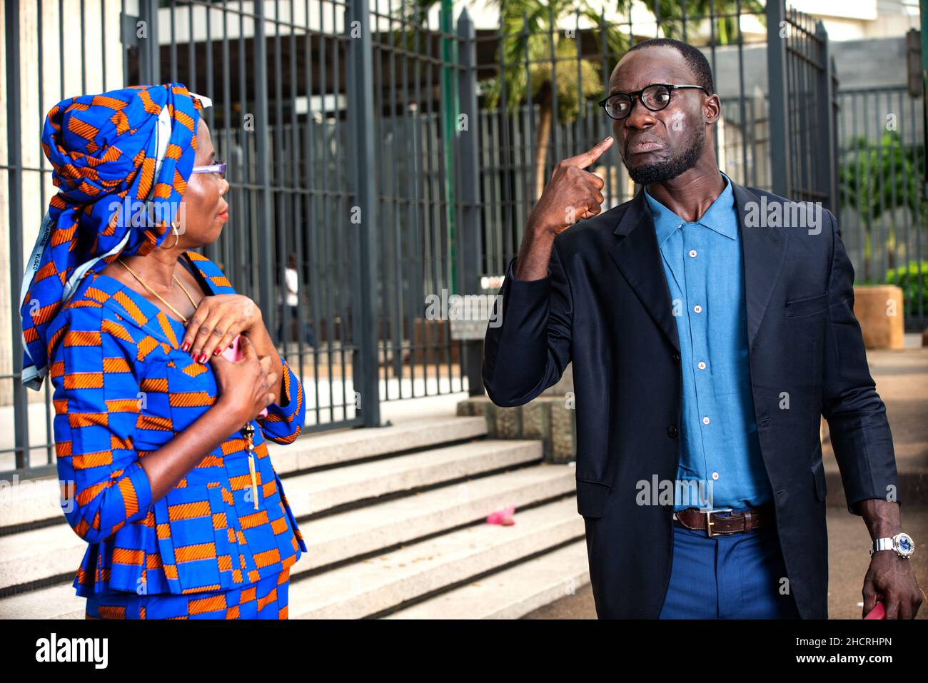 two adult business people arguing outside. man pointing finger to the ...