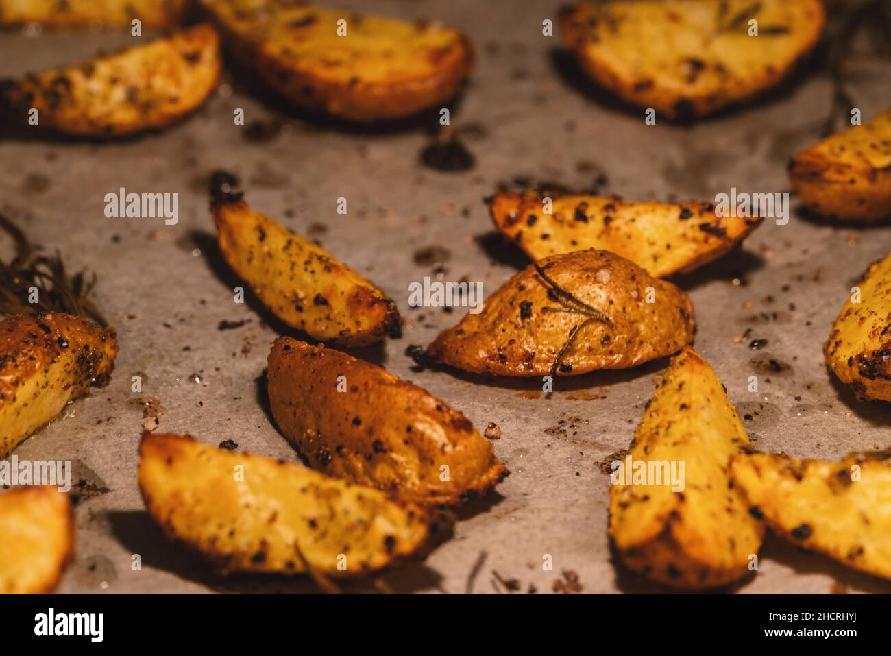 Baked potato wedges on baking paper - homemade organic vegetable vegan ...