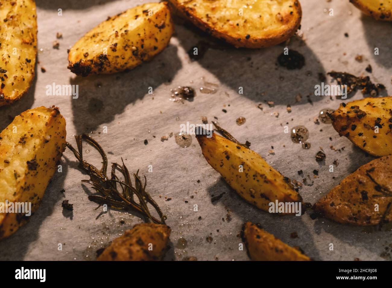 Baked potato wedges with rosemary and oil in a oven - homemade organic ...