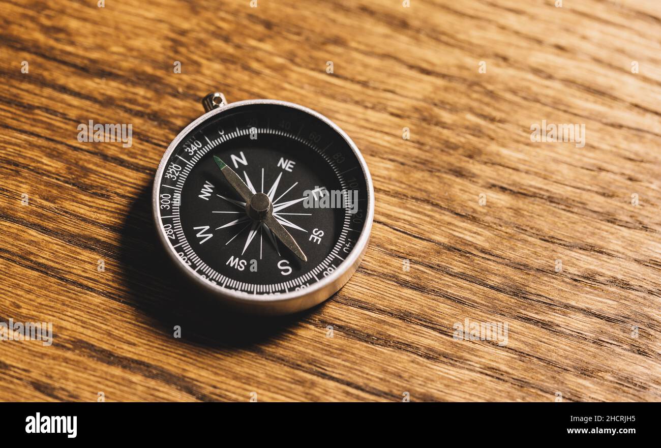 compass on wood background concept for direction, travel, guidance or ...