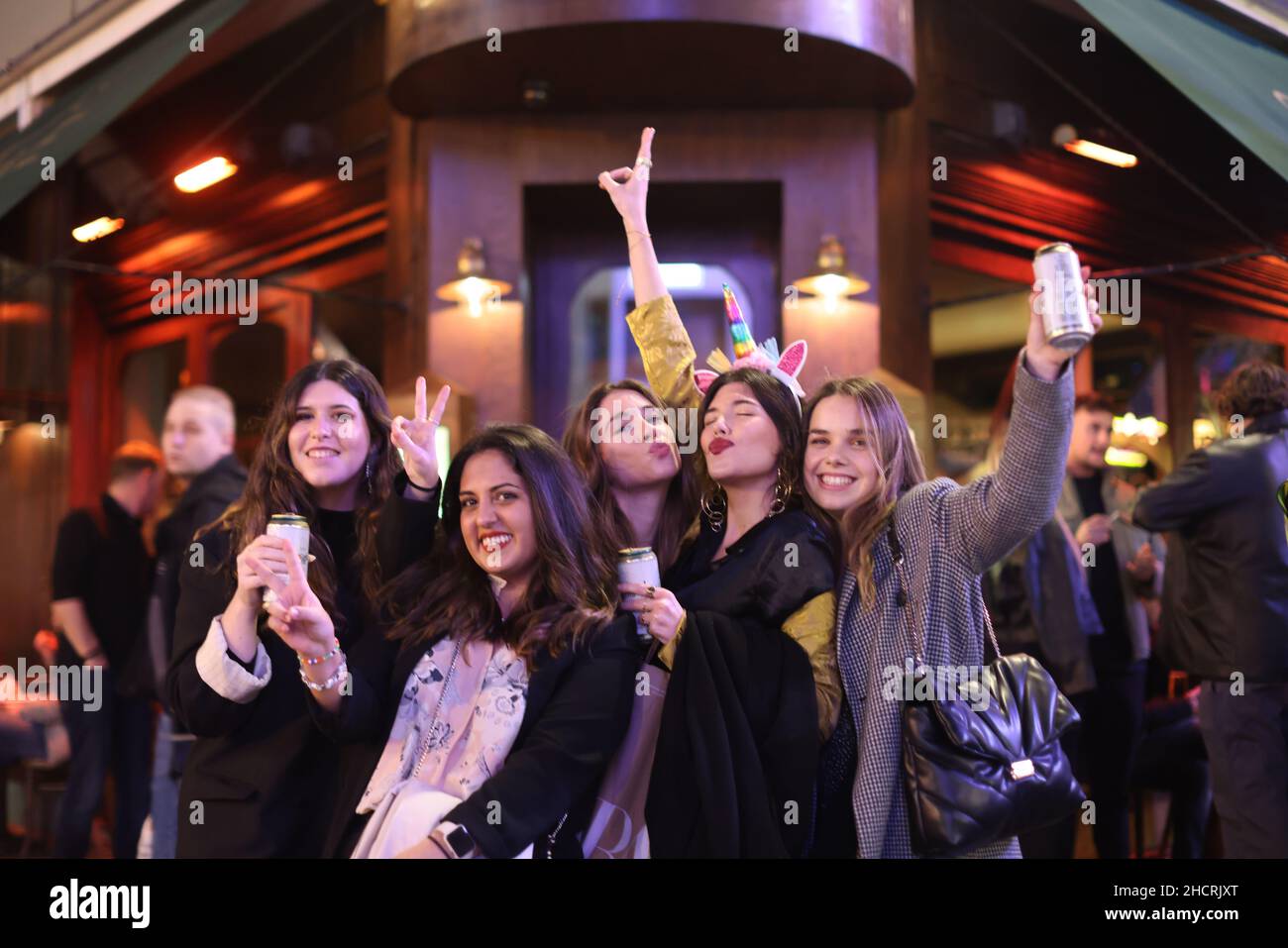 Revellers pose for a photo ahead of New Year's Eve celebrations in Old ...