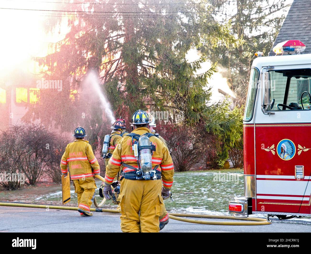 Firefighter at working fire with dramatic flames Stock Photo - Alamy