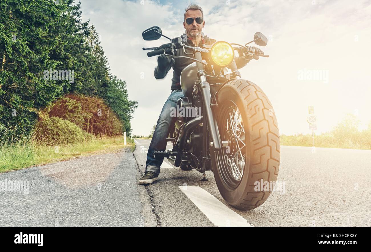 motorbiker parking on the road right side and sunset. ready to a ...