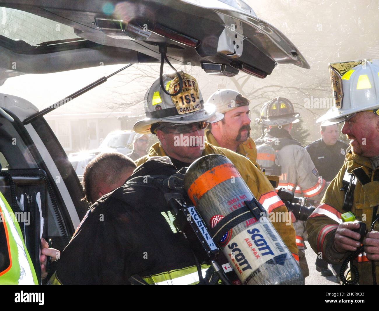 Firefighters on scene, smoke, no fire Stock Photo - Alamy