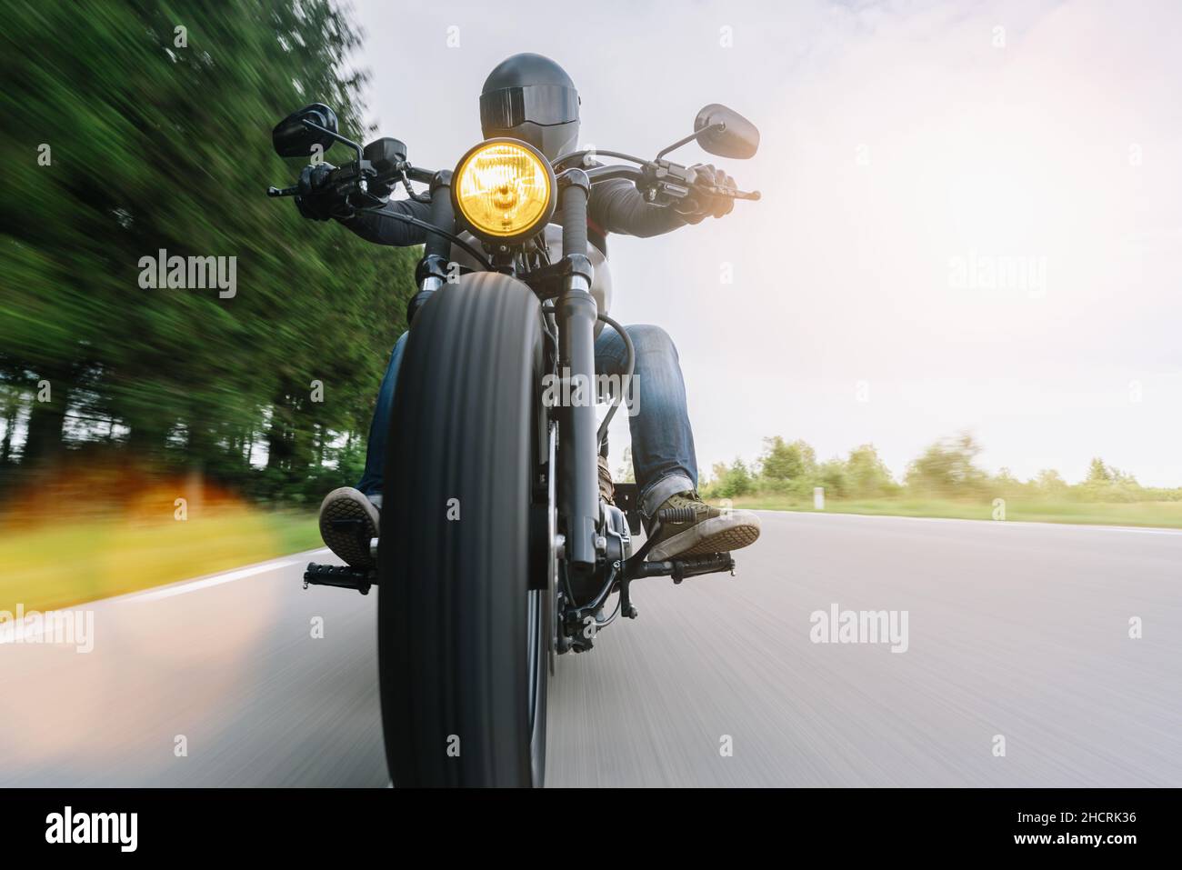 motorbike chopper on the road riding at sunset. having fun driving the ...