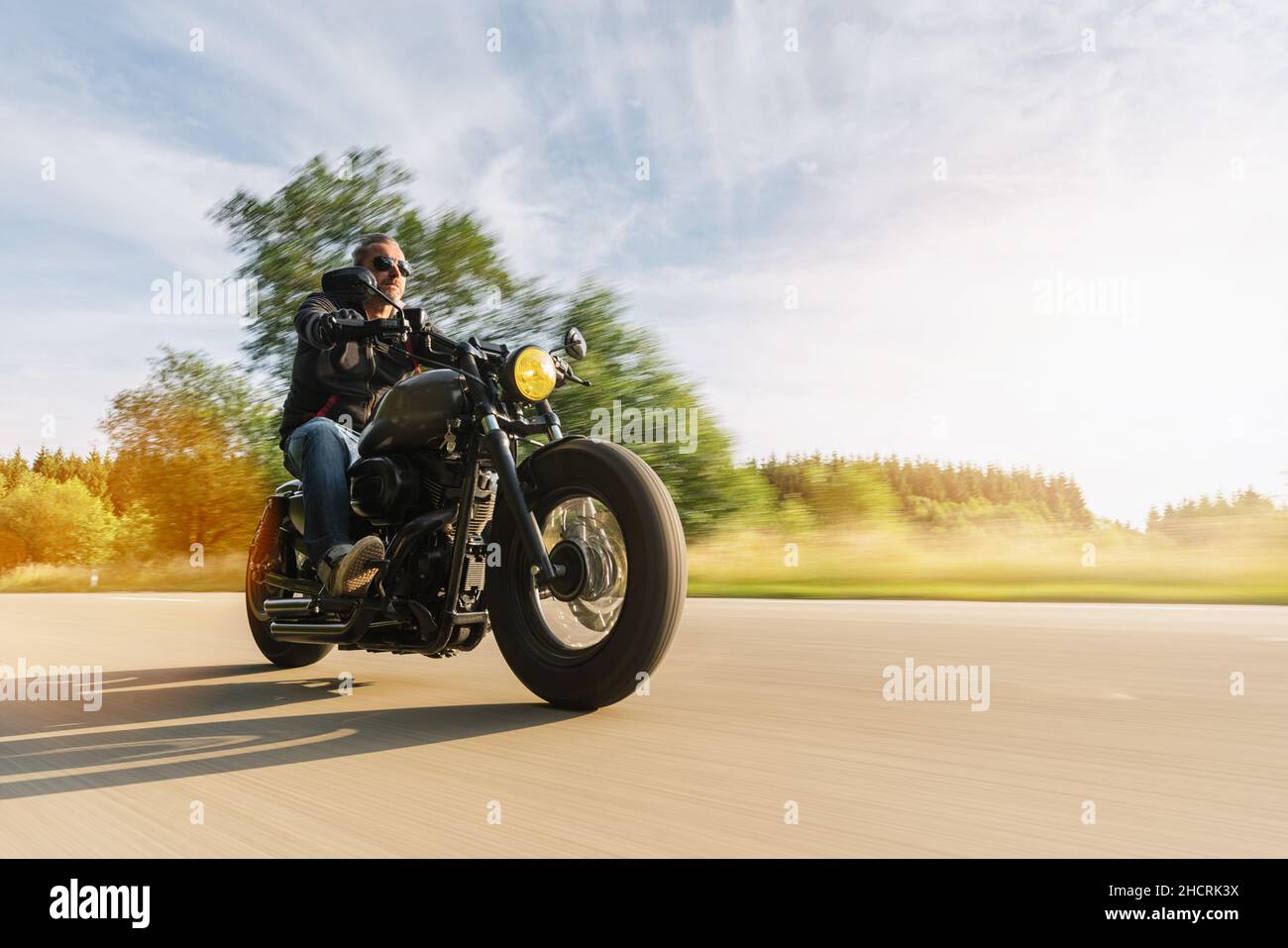 High power motorbike chopper on the country road riding at summer ...