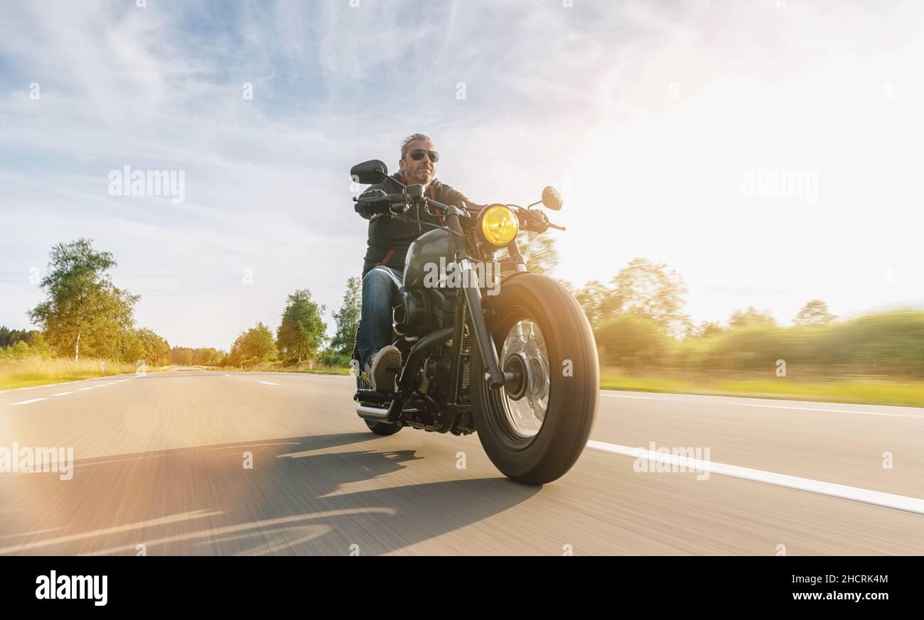 Motorcycle driver riding cruiser on the highway, central Europe Stock ...