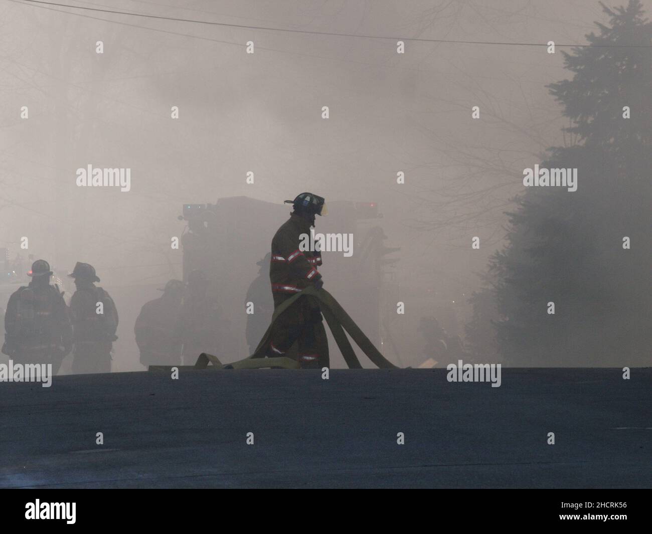 Firefighters on scene, smoke, no fire Stock Photo - Alamy