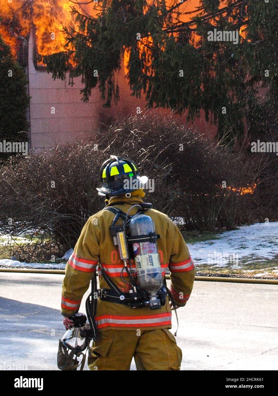 Firefighter at working fire with dramatic flames Stock Photo - Alamy