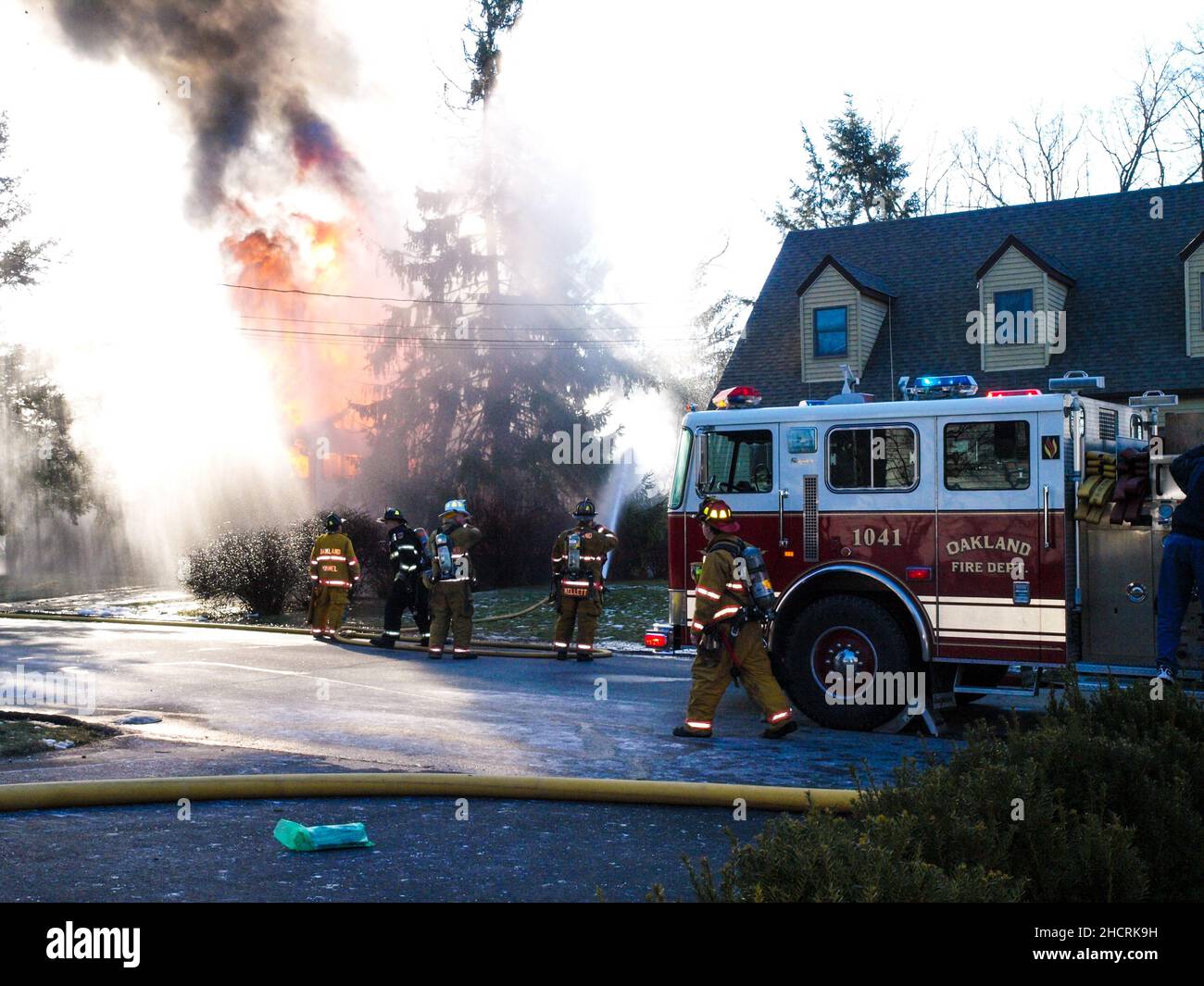 Firefighter at working fire with dramatic flames Stock Photo - Alamy