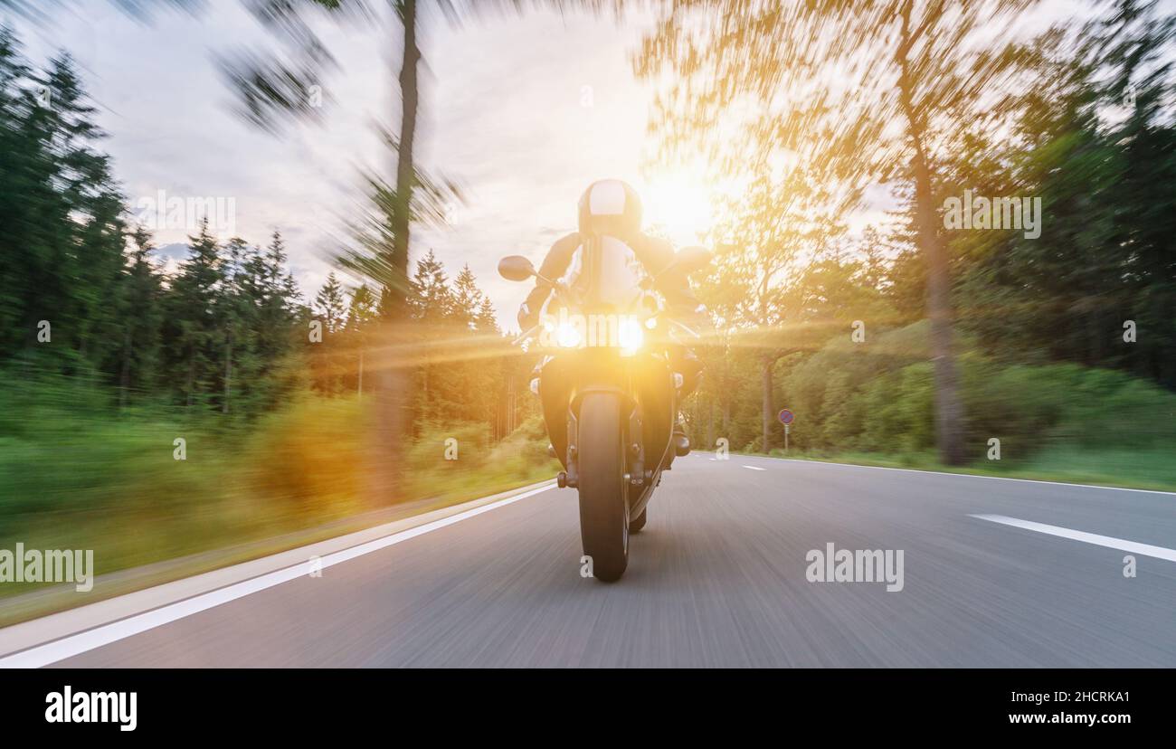 motorbike on the forest road riding with spotlights. driving on the ...