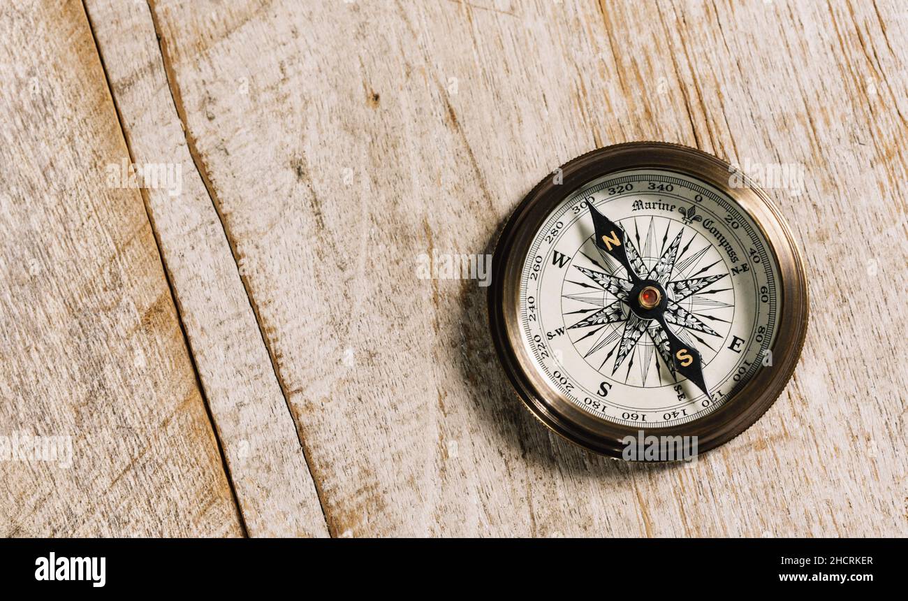 old compass on wood background concept for direction, travel, guidance ...