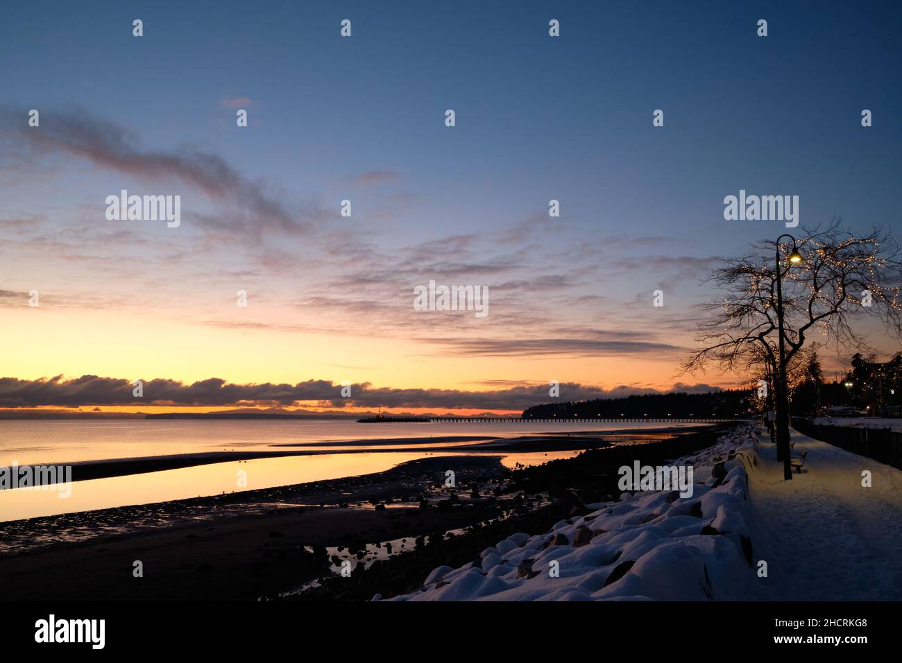 Quiet waterfront promenade in White Rock, BC, after a snowfall. Lights ...