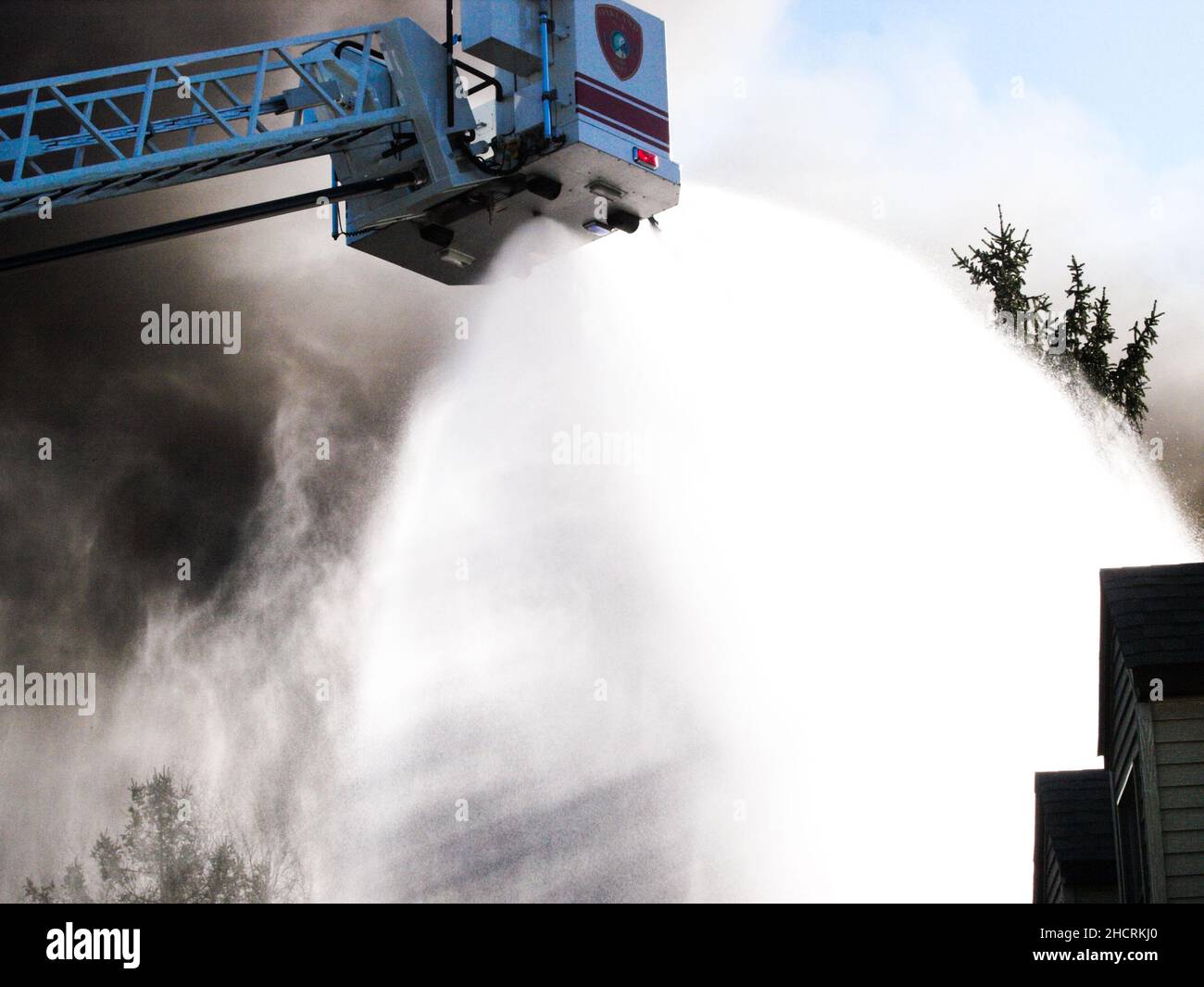 Fire snorkel spraying water on fire from above Stock Photo - Alamy