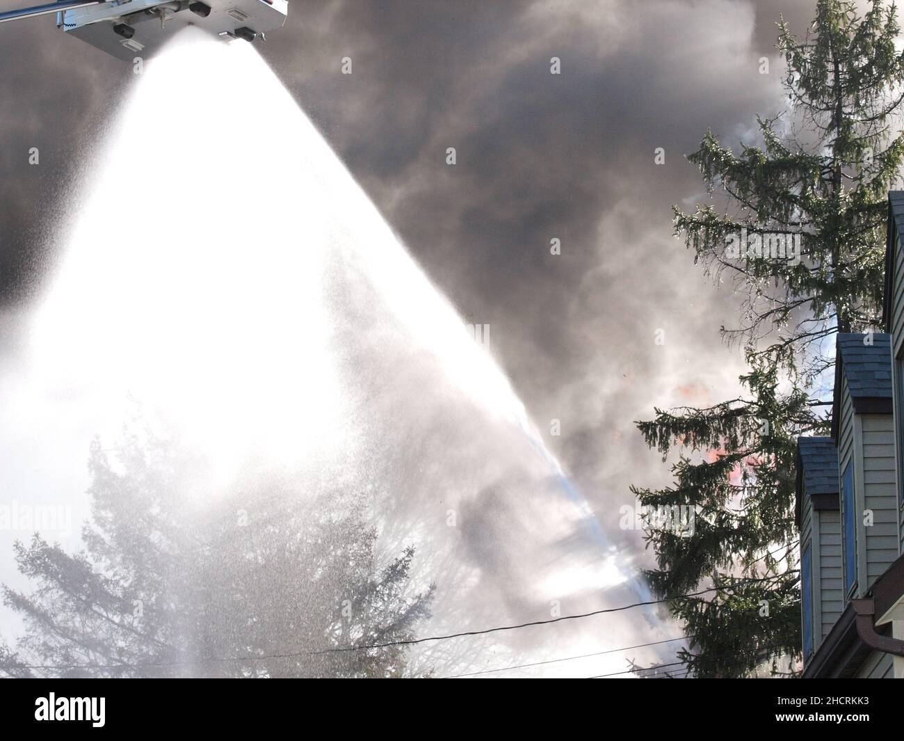 Fire snorkel spraying water on fire from above Stock Photo - Alamy
