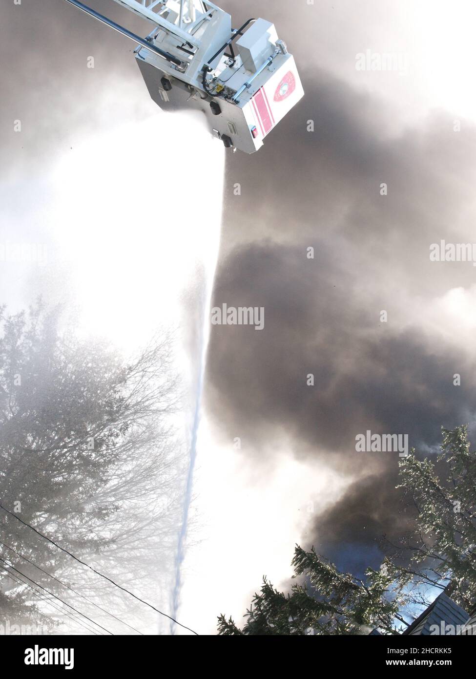 Fire snorkel spraying water on fire from above Stock Photo - Alamy
