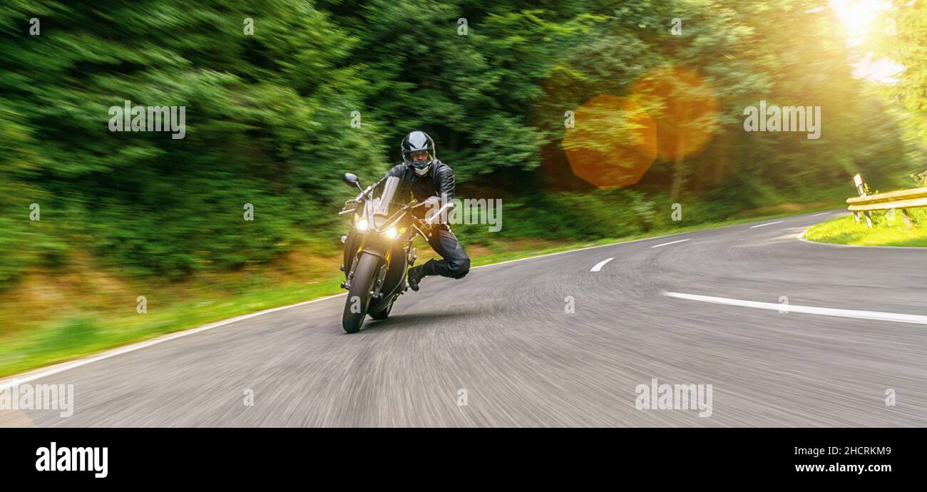 Motorbike on the forest road riding. having fun driving the empty road ...