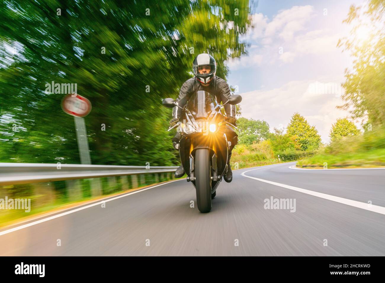 motorbike riding on the road with traffic sign. driving on the empty ...