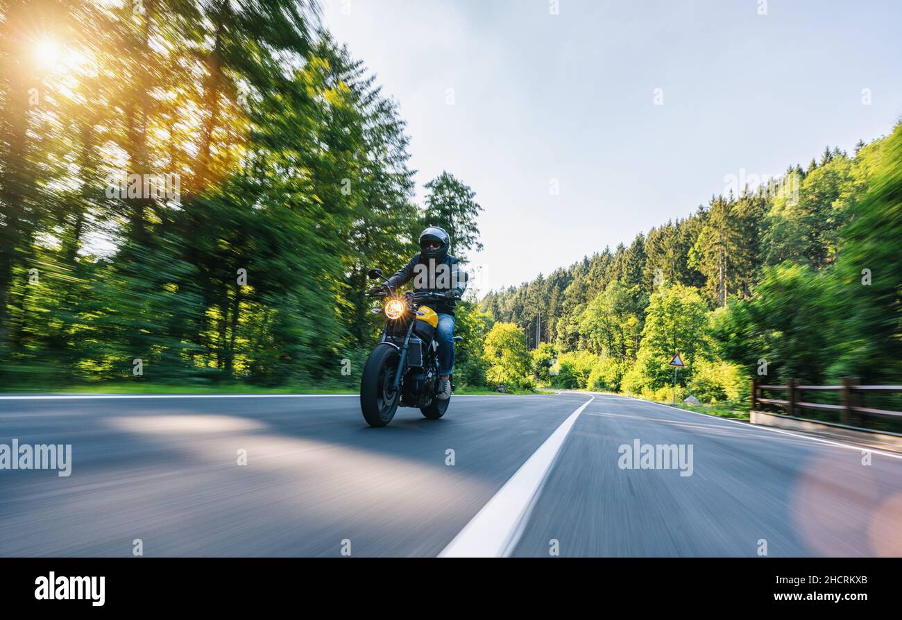 motorbike on the Alpine highway riding. having fun driving the empty ...