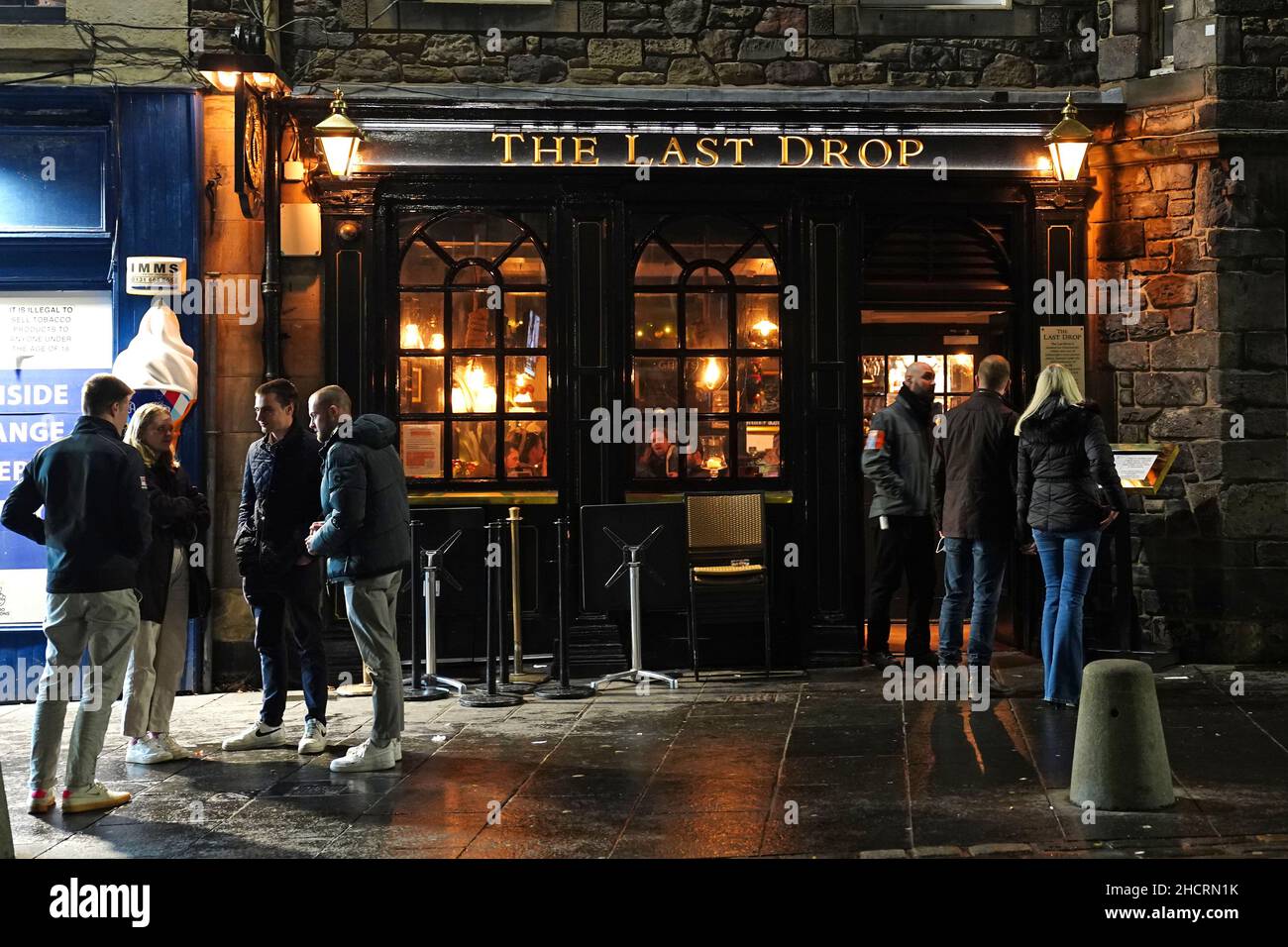 A handful of people outside The Last Drop pub in the Grassmarket ...
