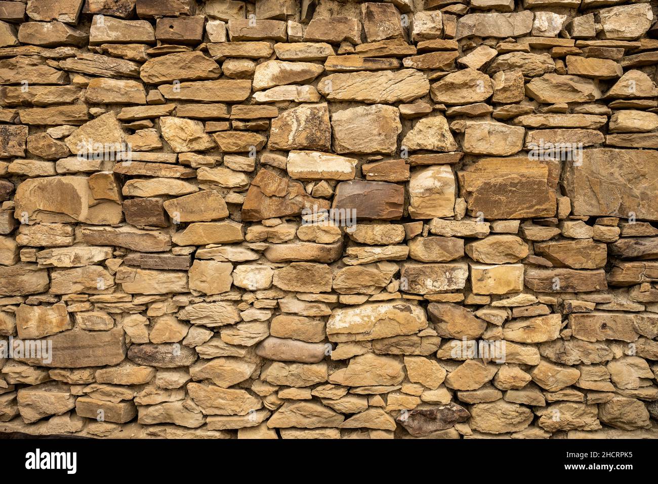 Wide Shot of Stacked Stone Wall with beige Rocks background image Stock ...