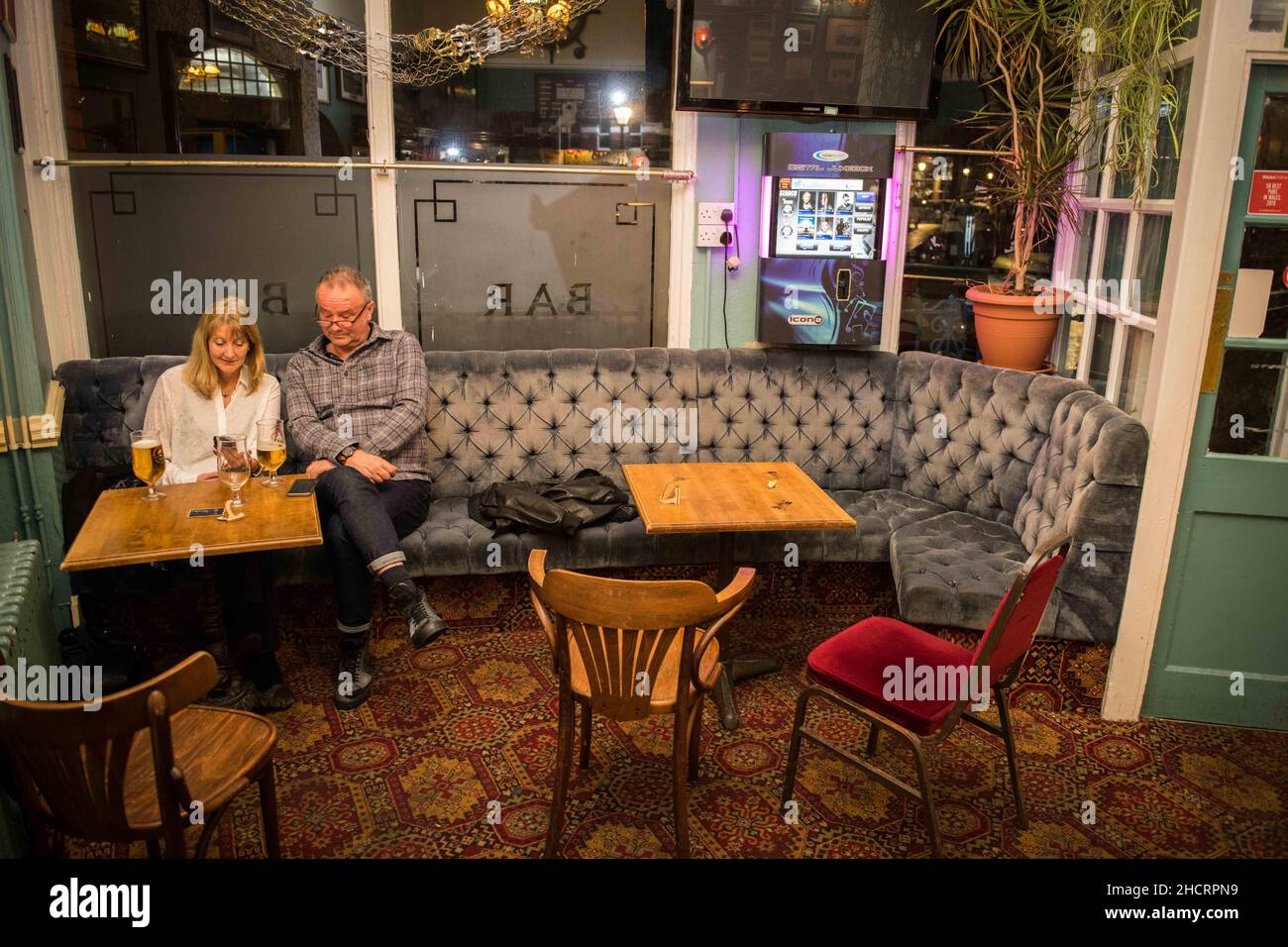 Two people sit at their table inside the Queens pub in Swansea on New ...