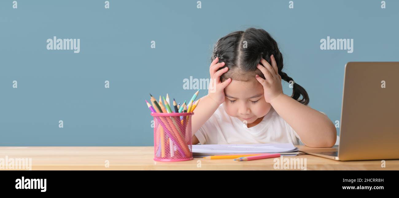 Tired asian kids girl stay at home and learn from home. Unmotivated ...