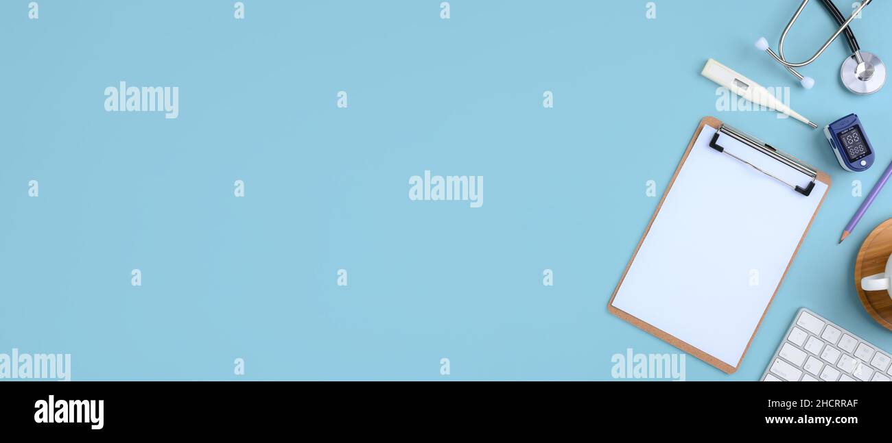 Top view of doctor desk table with stethoscope, blank paper on ...