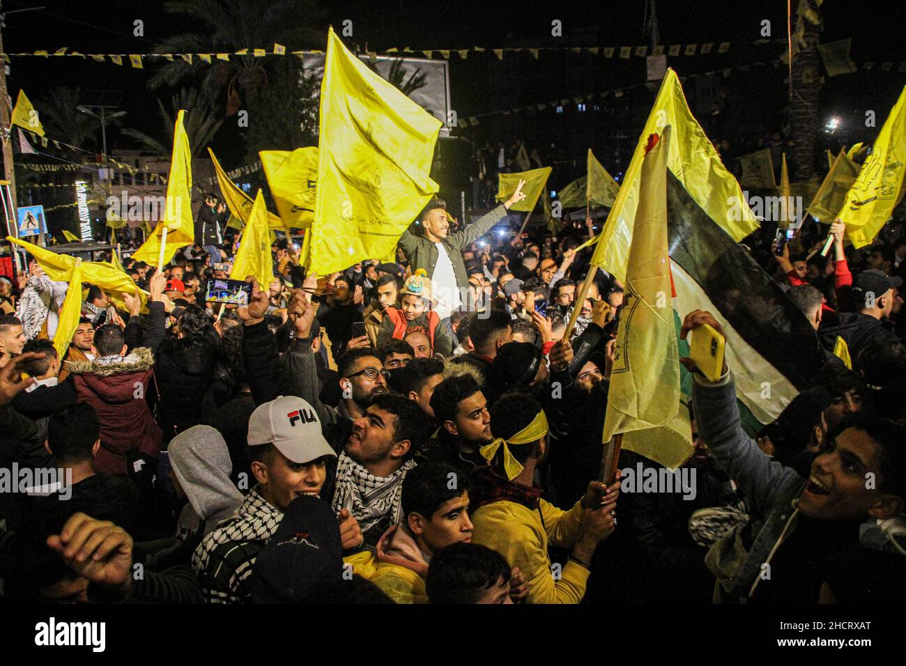 Palestinian Fatah supporters wave their yellow flags during a rally ...