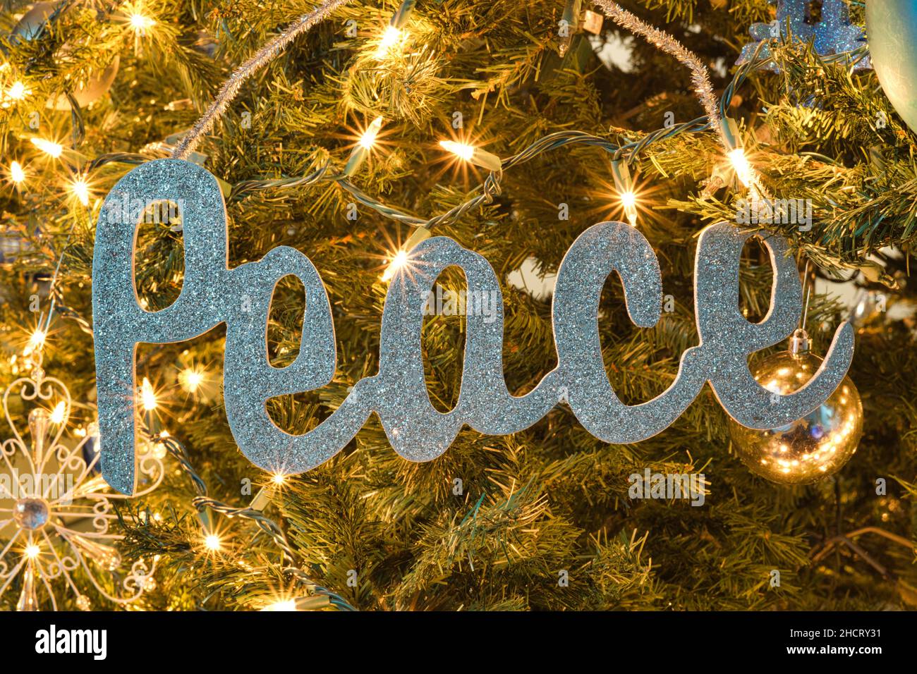 Peace sign hanging as a Christmas tree decoration surrounded by ...