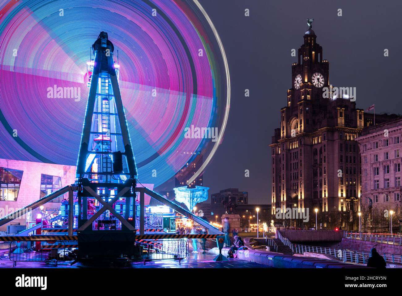 Long Exposure of fun fair ride in front of the Liver Building during ...